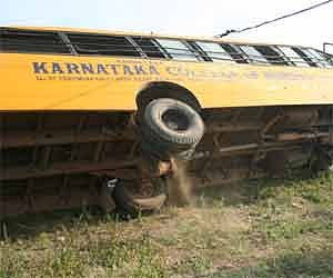 Bus skids off road, falls into a pit