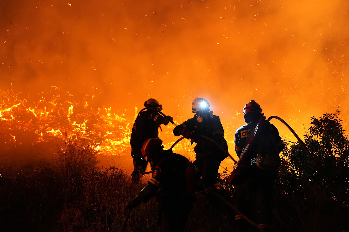 Firefighters battle wildfire burning out of control on the Greek island ...